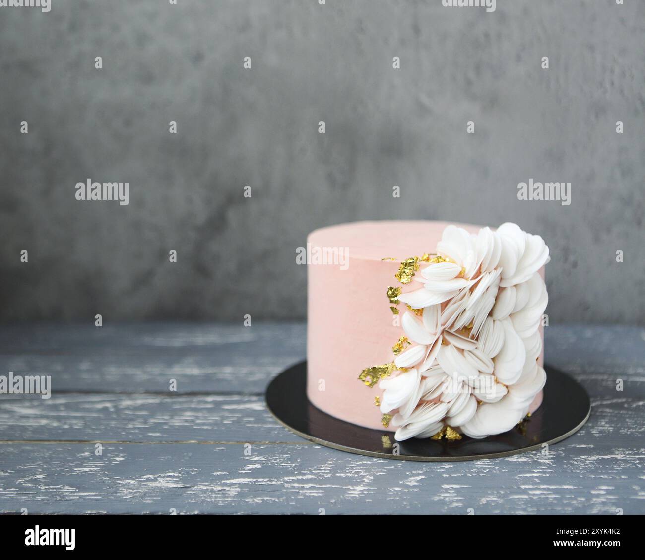 Mini pink wedding cake with wafer paper and gold decor Stock Photo - Alamy