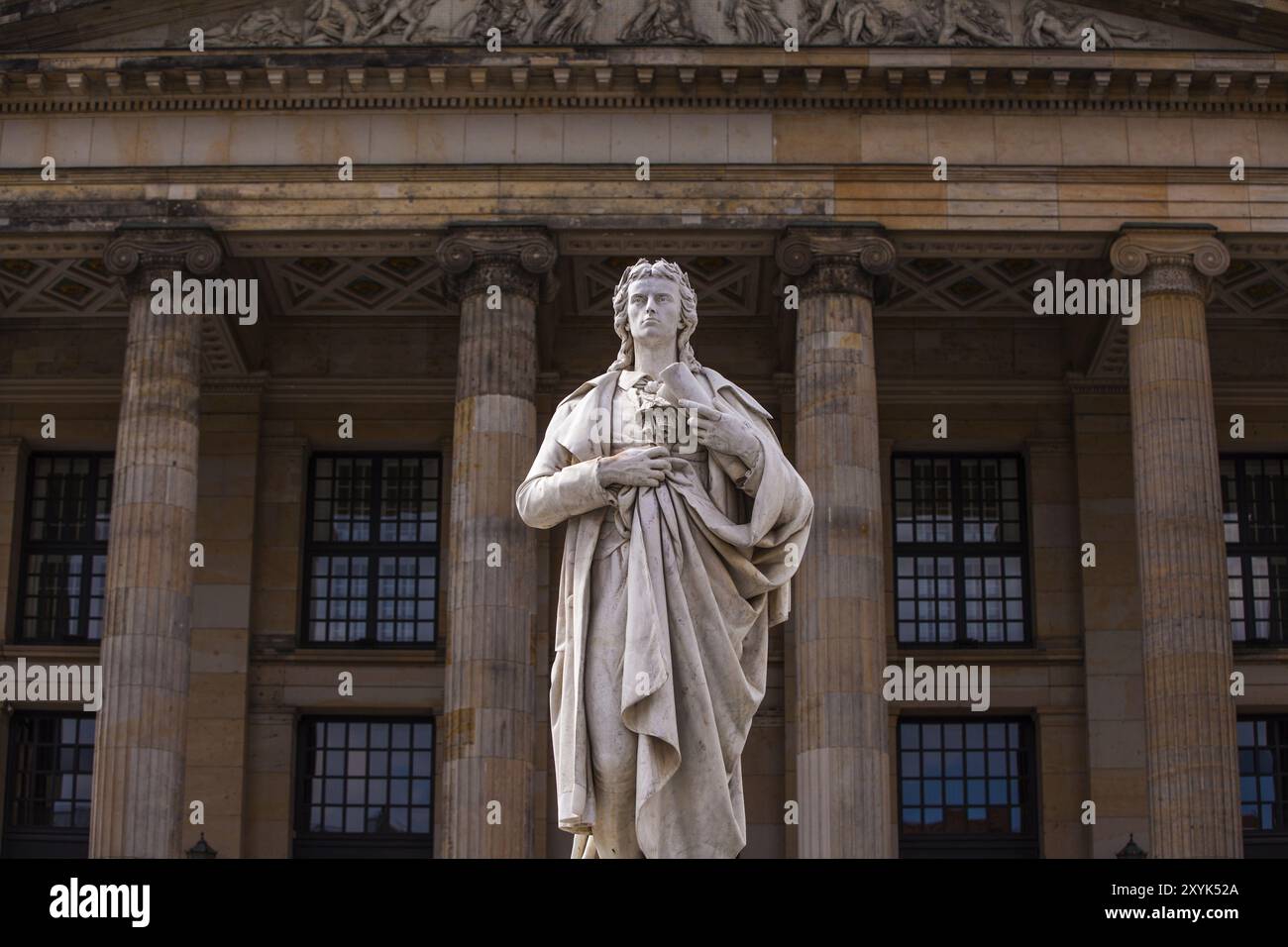 Schiller statue with scroll and concert hall in the background Stock ...