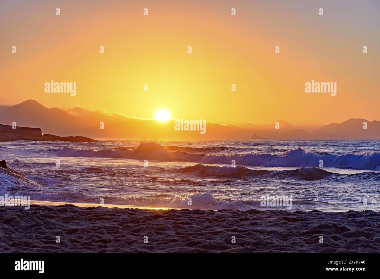 Tropical sunrise at Devil beach with Copacabana Fort in the background ...