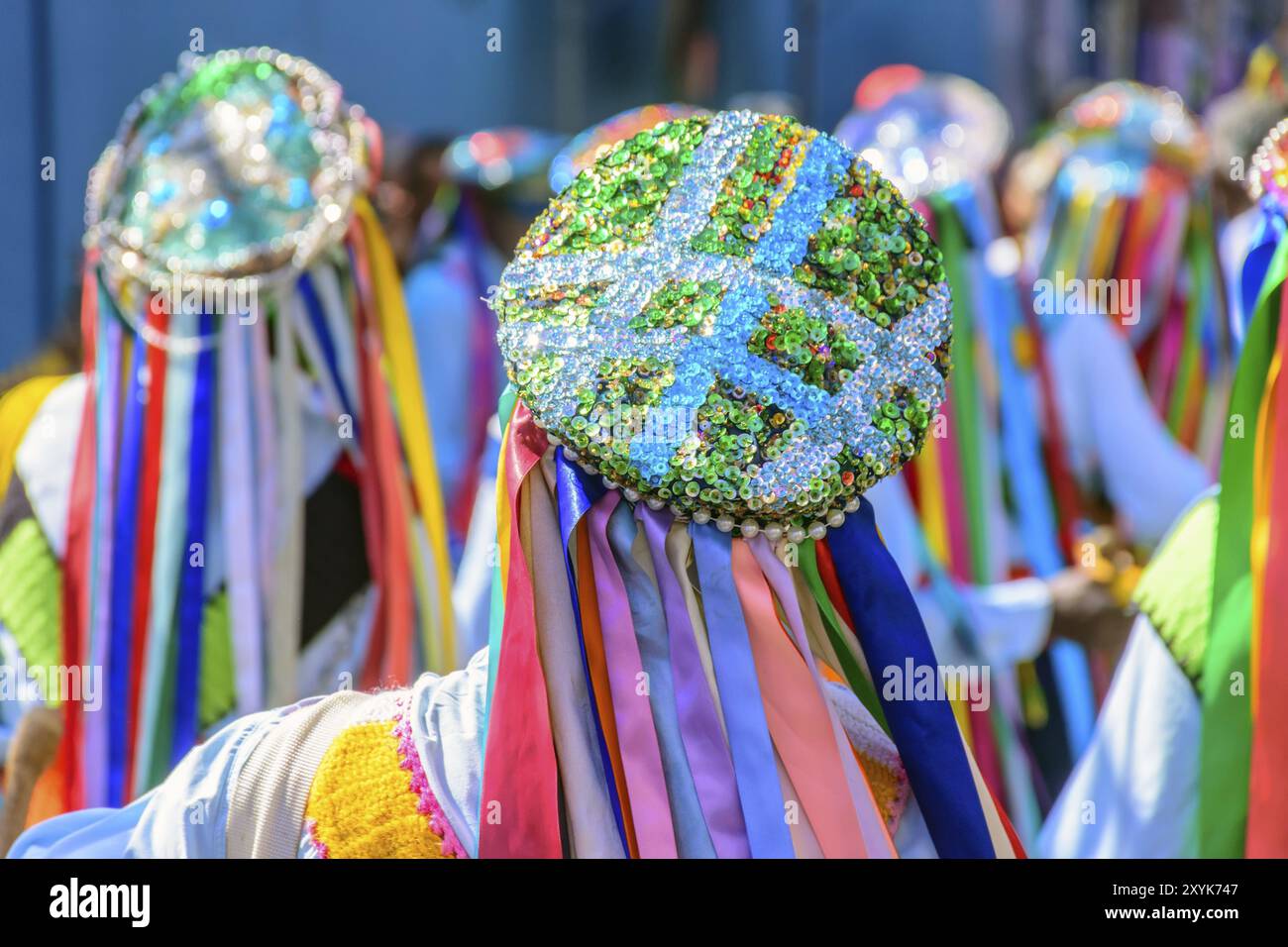 Men dressed in colorful clothes and hats attending a popular religious ...