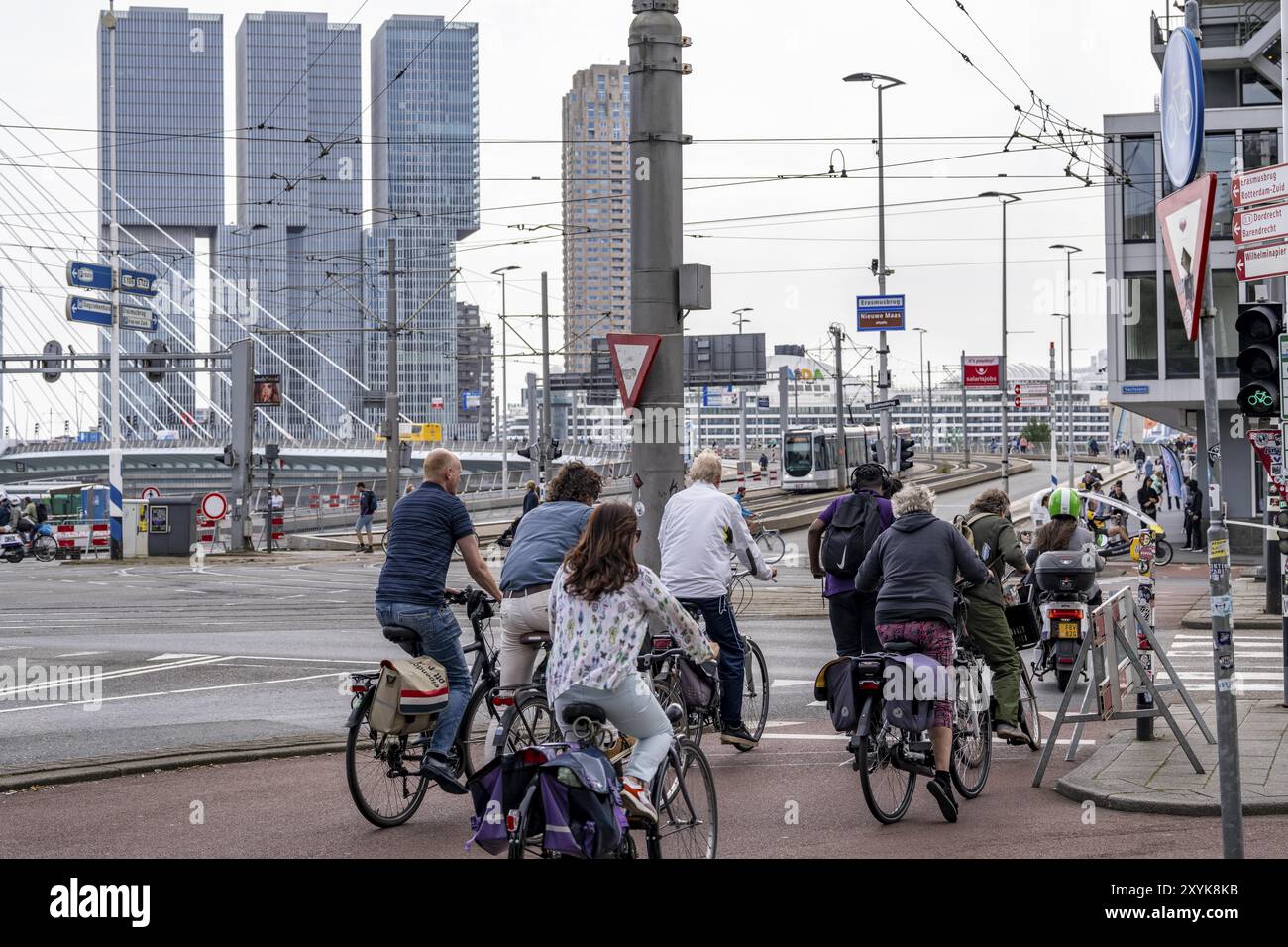 Cyclist on cycle path in front of the Erasmus Bridge over the Nieuwe ...