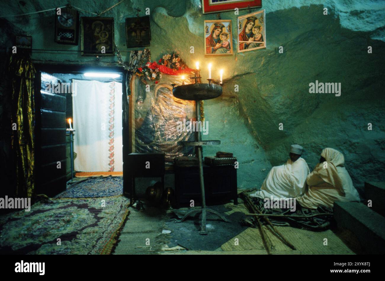 A man and a woman praying inside an old Coptic Christian church in a ...