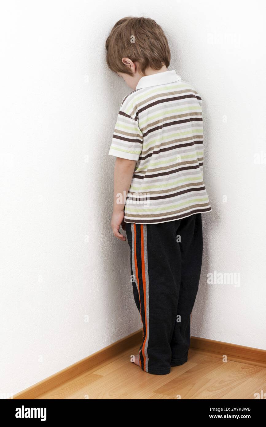 Little child boy wall corner punishment standing Stock Photo - Alamy