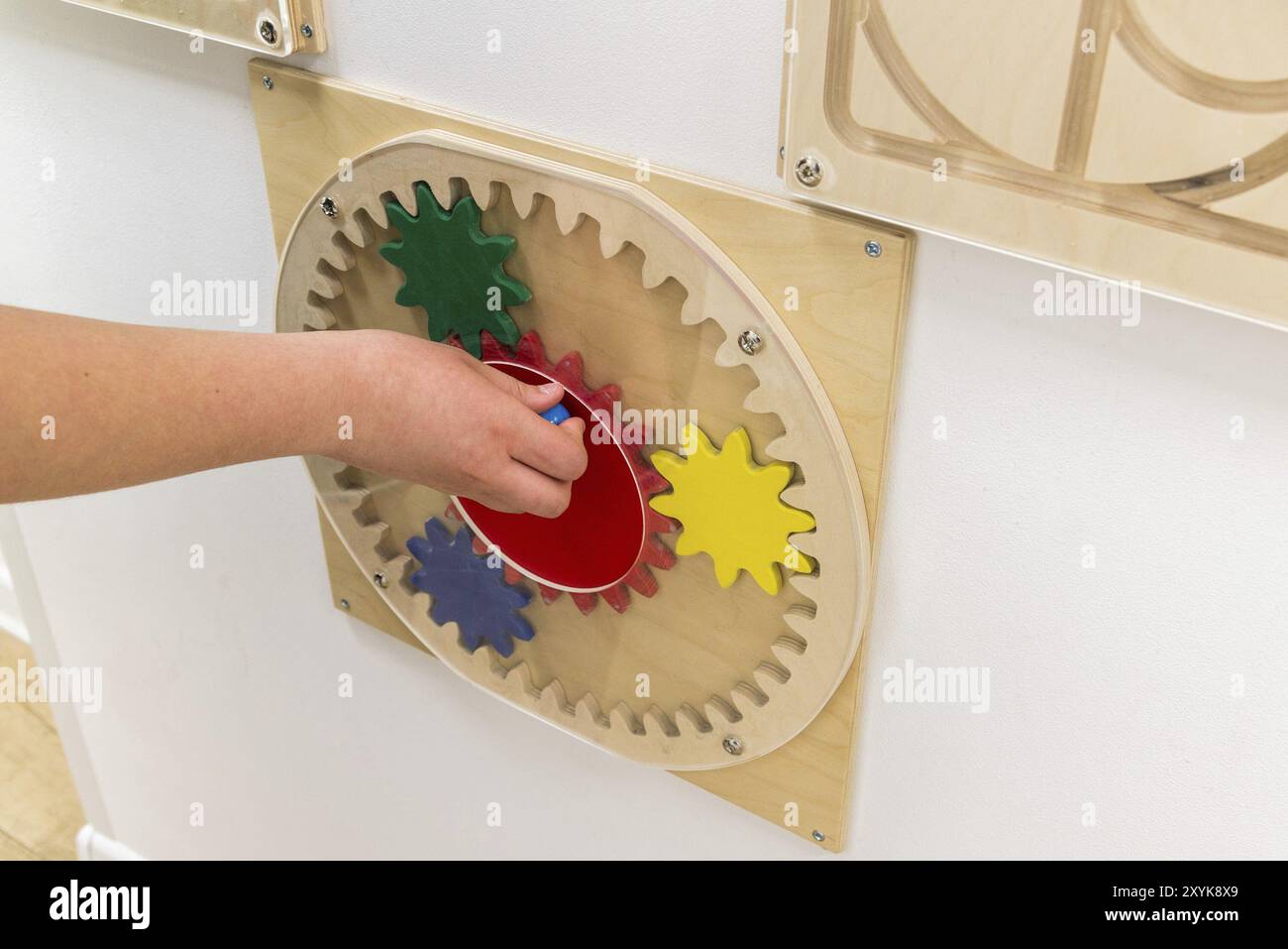 Child playing of educational games hanging on the wall Stock Photo - Alamy