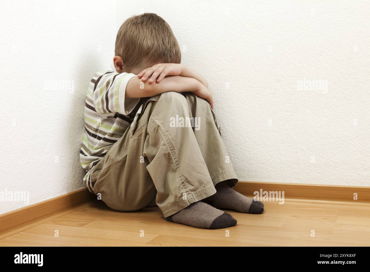 Little child boy wall corner punishment standing Stock Photo - Alamy