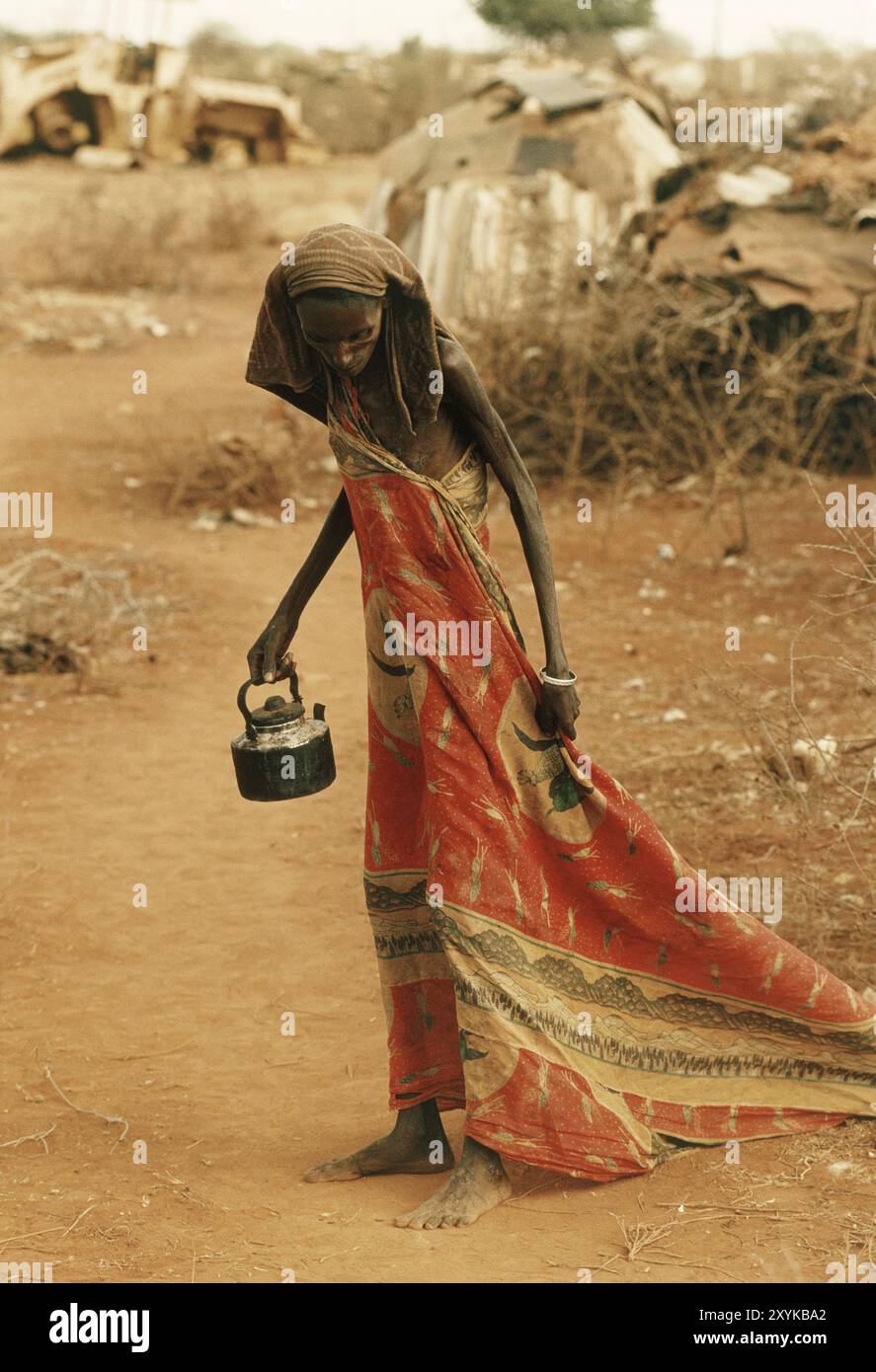 A severly malnourished woman in Baidoa, Somalia, makes her way to a ...
