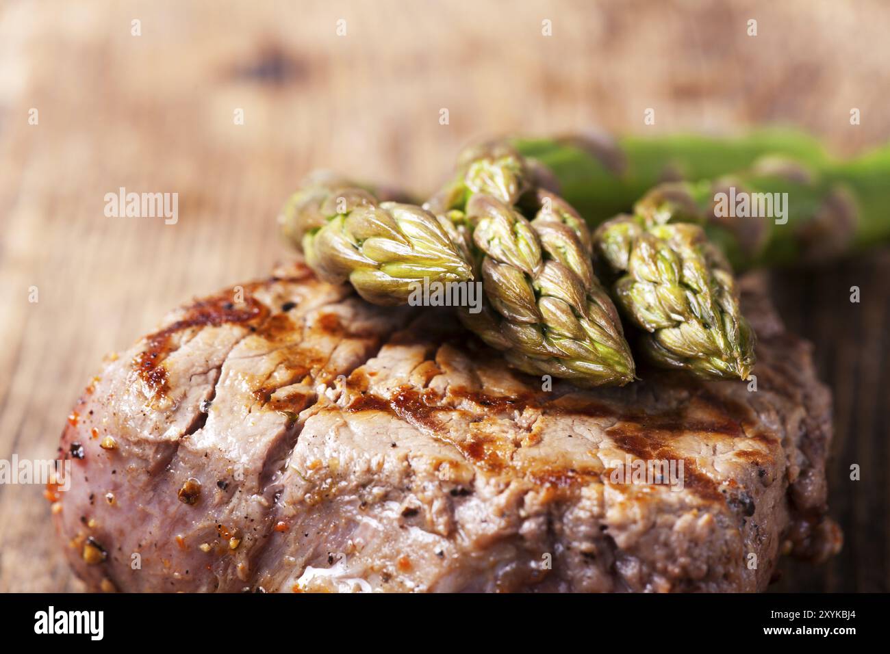 Juicy grilled steak with asparagus Stock Photo - Alamy