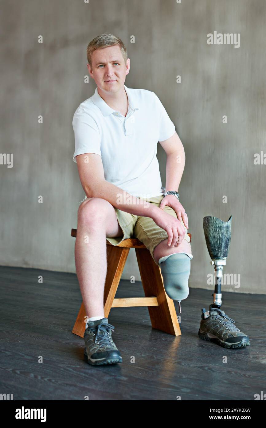 Man, portrait and amputee with prosthetic leg, sitting and residual ...
