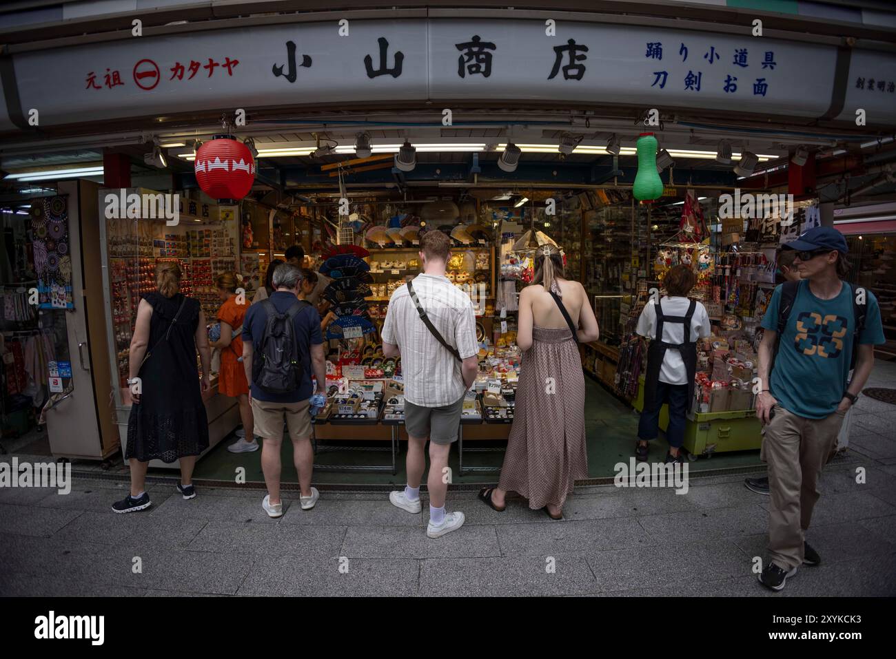 Tokyo, Japan. 29th Aug, 2024. Tourists look at wares inside a store in ...