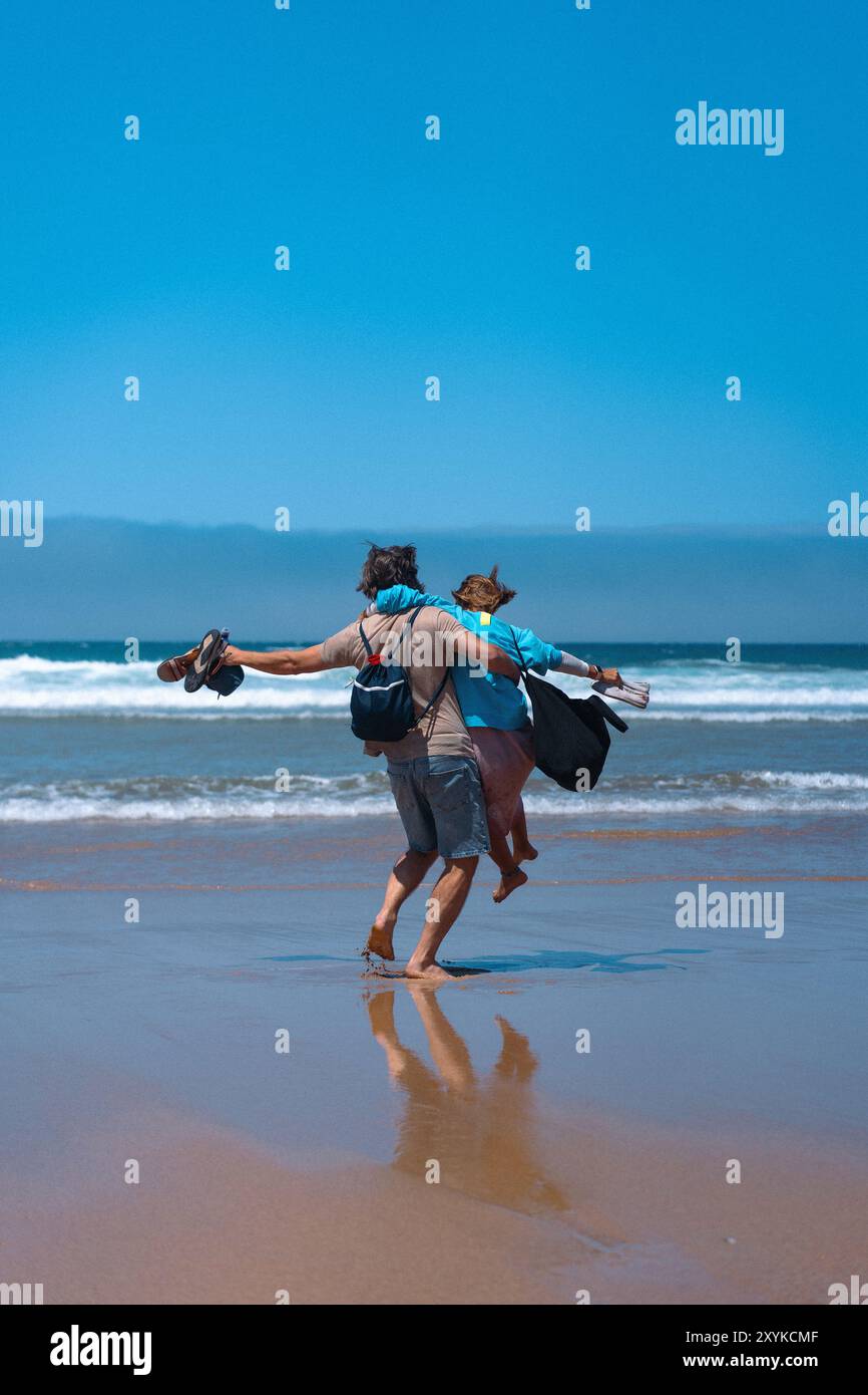Happy friends hugging on the beach Stock Photo - Alamy