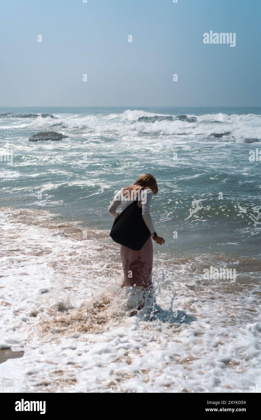 Rear view woman watching ocean hi-res stock photography and images - Alamy
