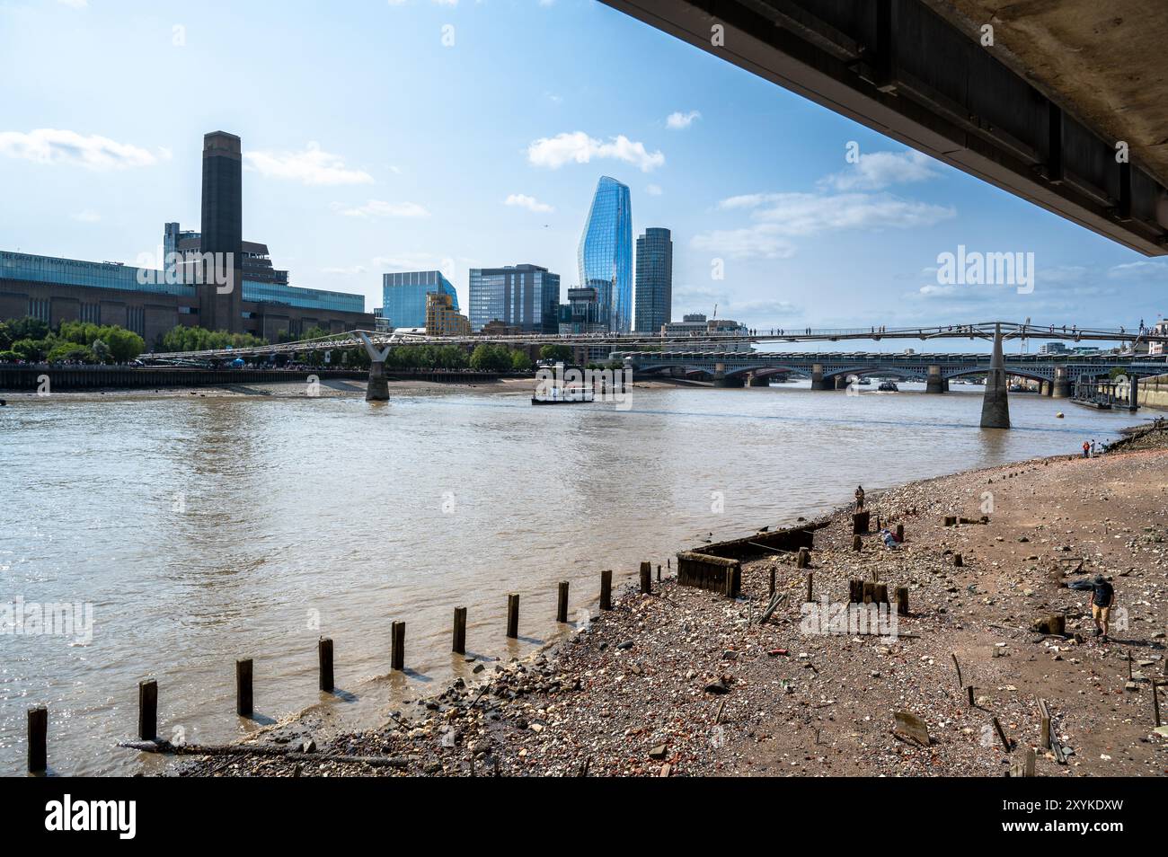 Low tide on the River Thames in summer with views of the Tate Modern ...