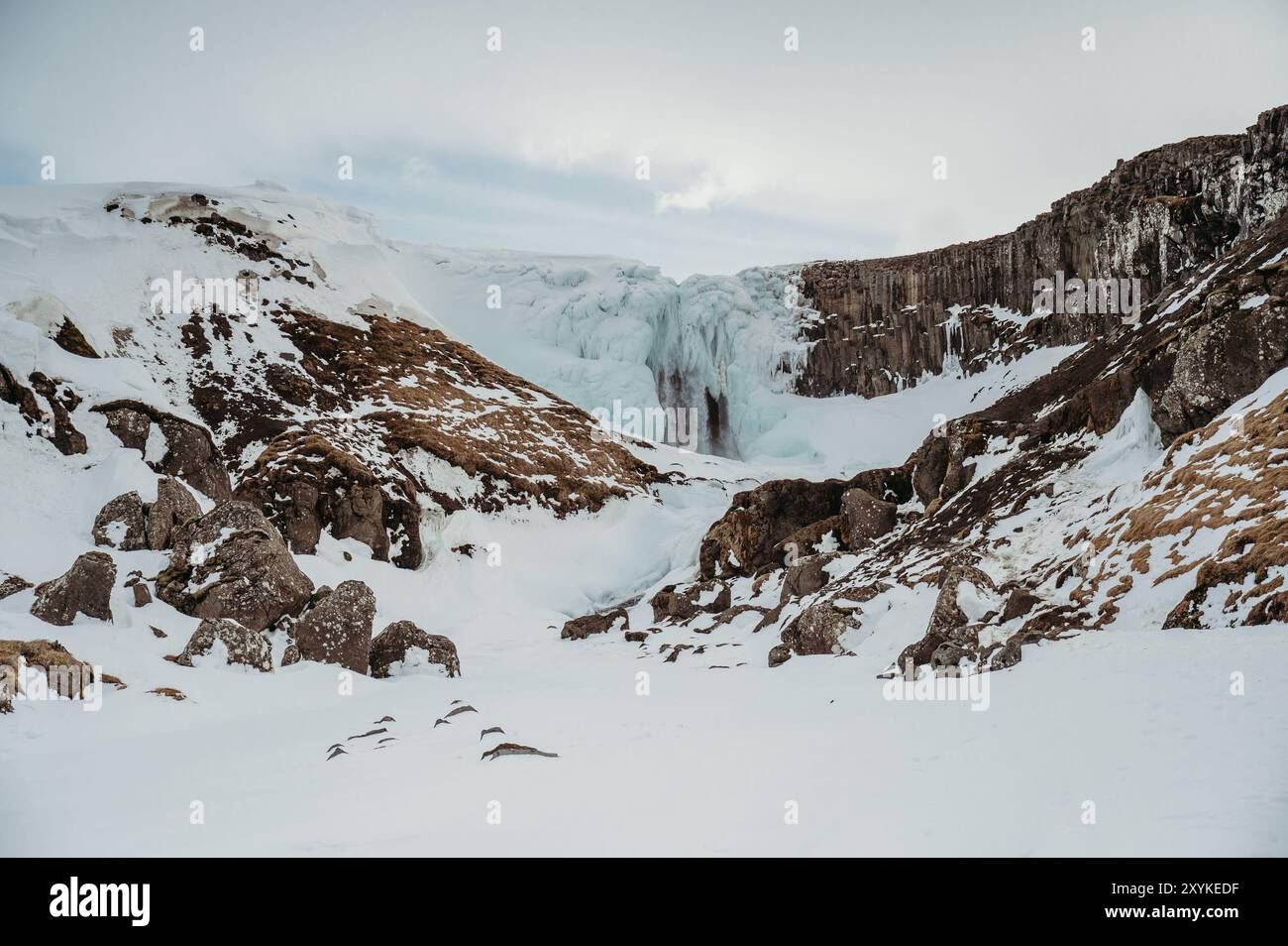 Frozen Svöðufoss waterfall with snow and basalt rocks in Iceland Stock ...
