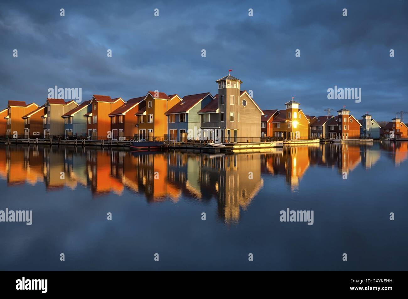 beautiful colorful buildings on water in gold sunshine, Reitdiephaven ...