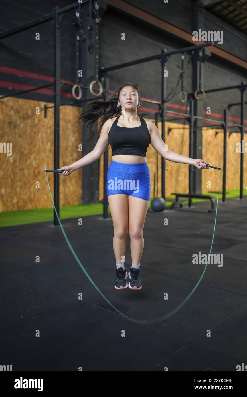 Vertical full length and frontal portrait of an Asian sportswoman ...