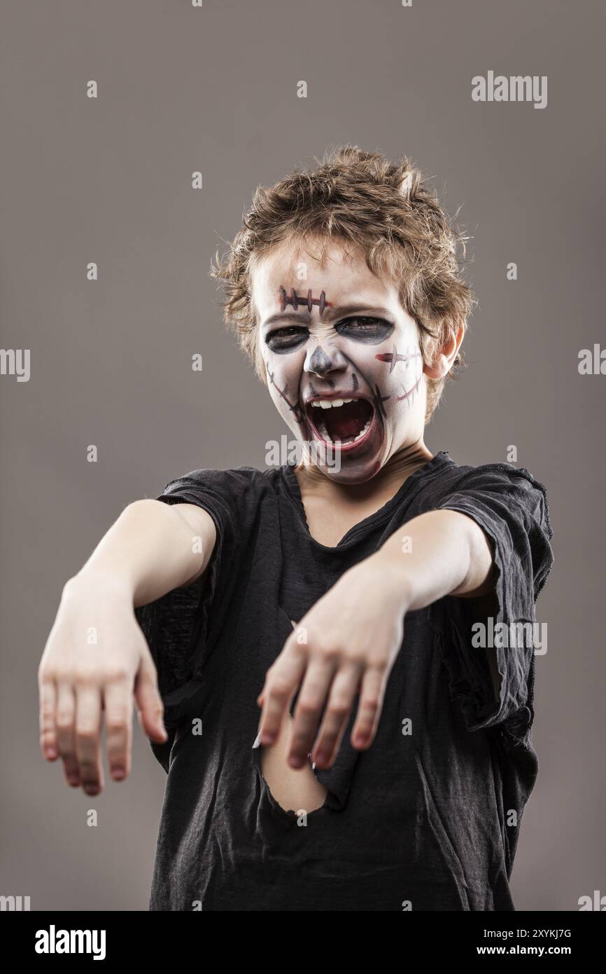 Halloween or horror concept, screaming walking dead zombie child boy ...