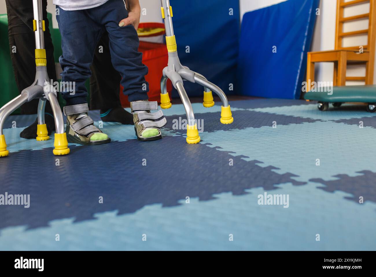 Young boy with movement disorders participates in physical therapy ...