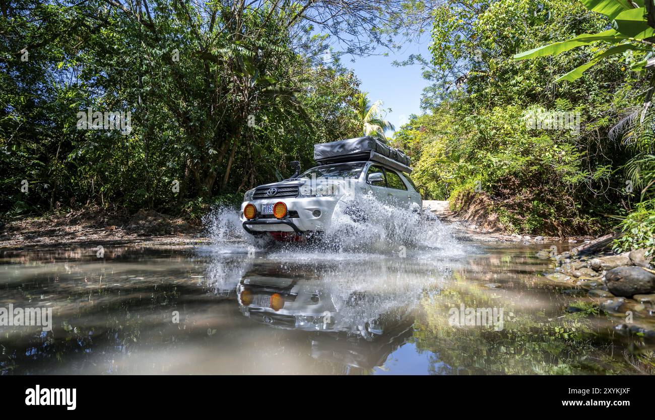 4x4 car drives through a river, water crossing with the off-road car ...