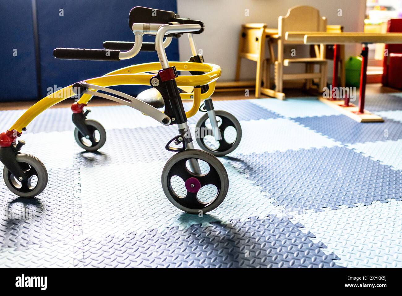 Bright therapy room features a yellow walker designed for children's ...