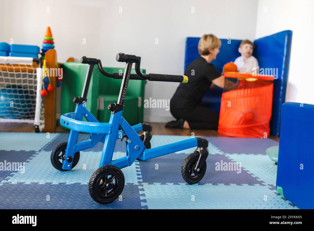 Children's walkers stand in rehabilitation room, in background a ...