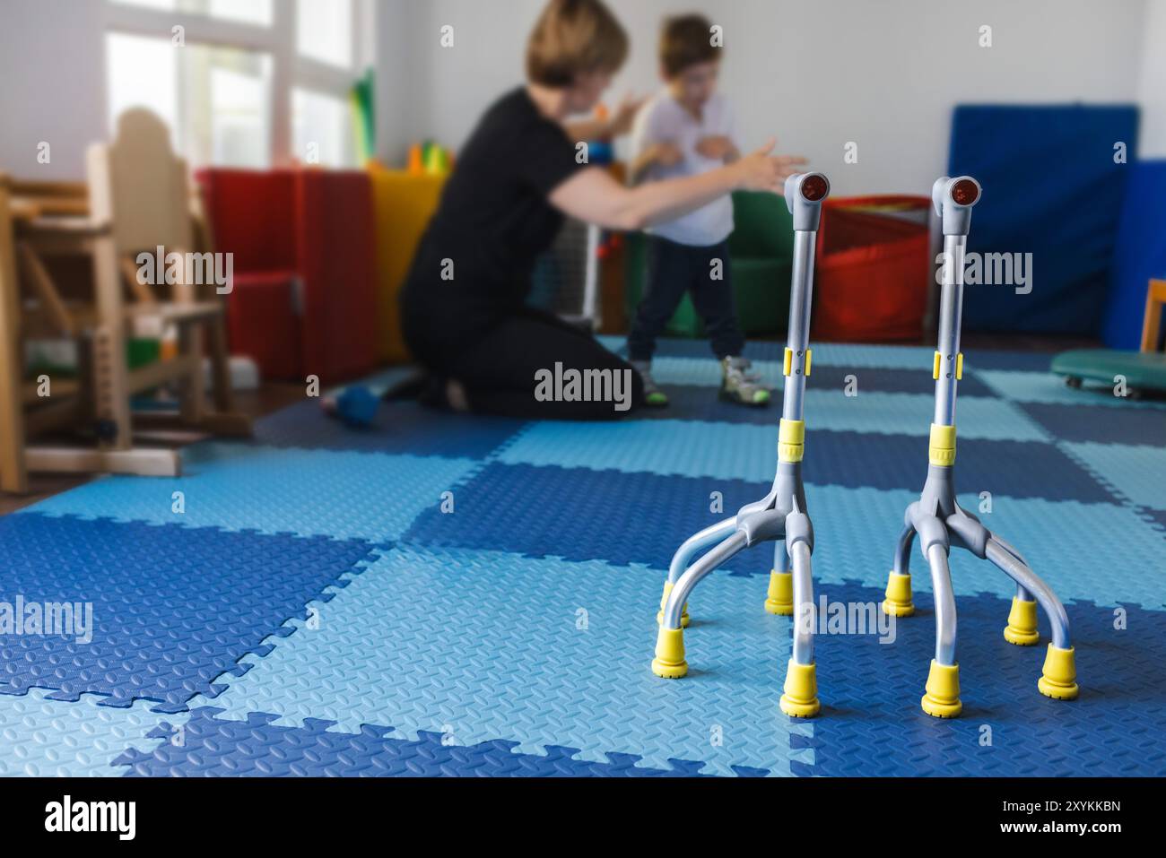 Young boy with cerebral palsy practices walking with support during a ...