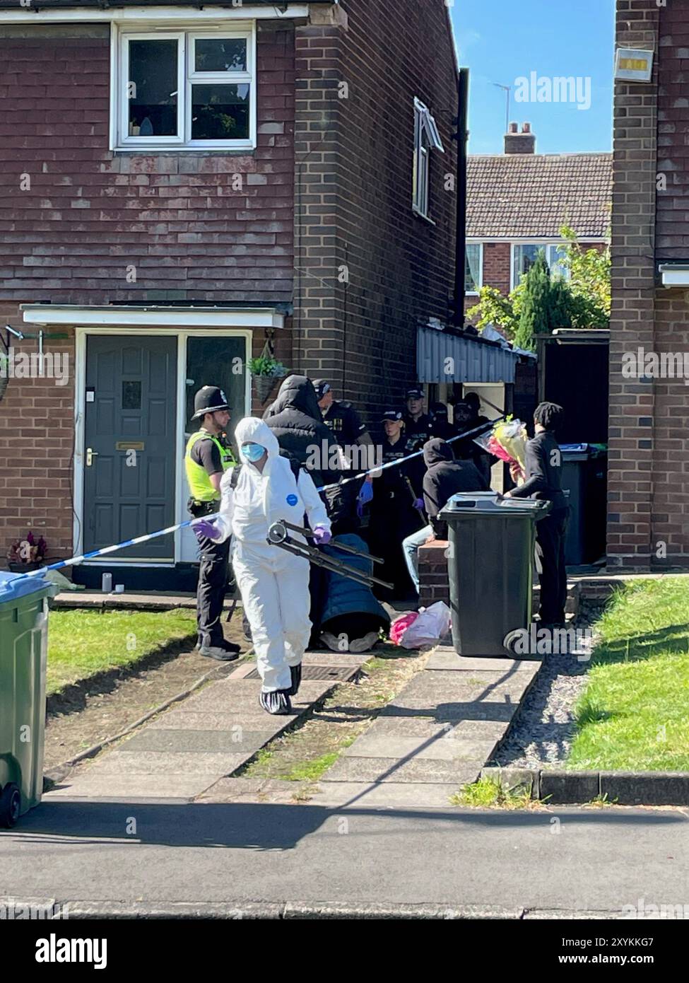 HOUSE NUMBER PIXELATED BY PA PICTURE DESK Police officers at the scene ...