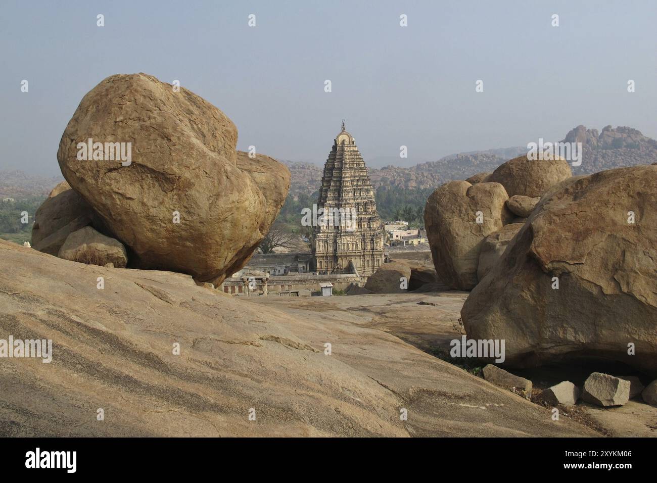 Scene in Hampi, India. Virupaksha Temple and big granite boulder ...