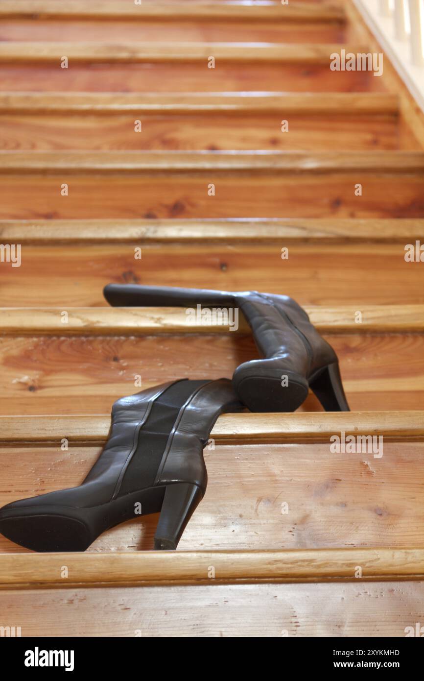 Women's boots on an oak wooden staircase Stock Photo - Alamy