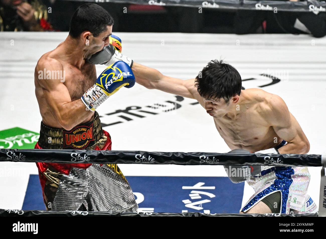 Japan's Seigo Yuri Akui (gray gloves) hits Ukraine's Artem Dalakian ...