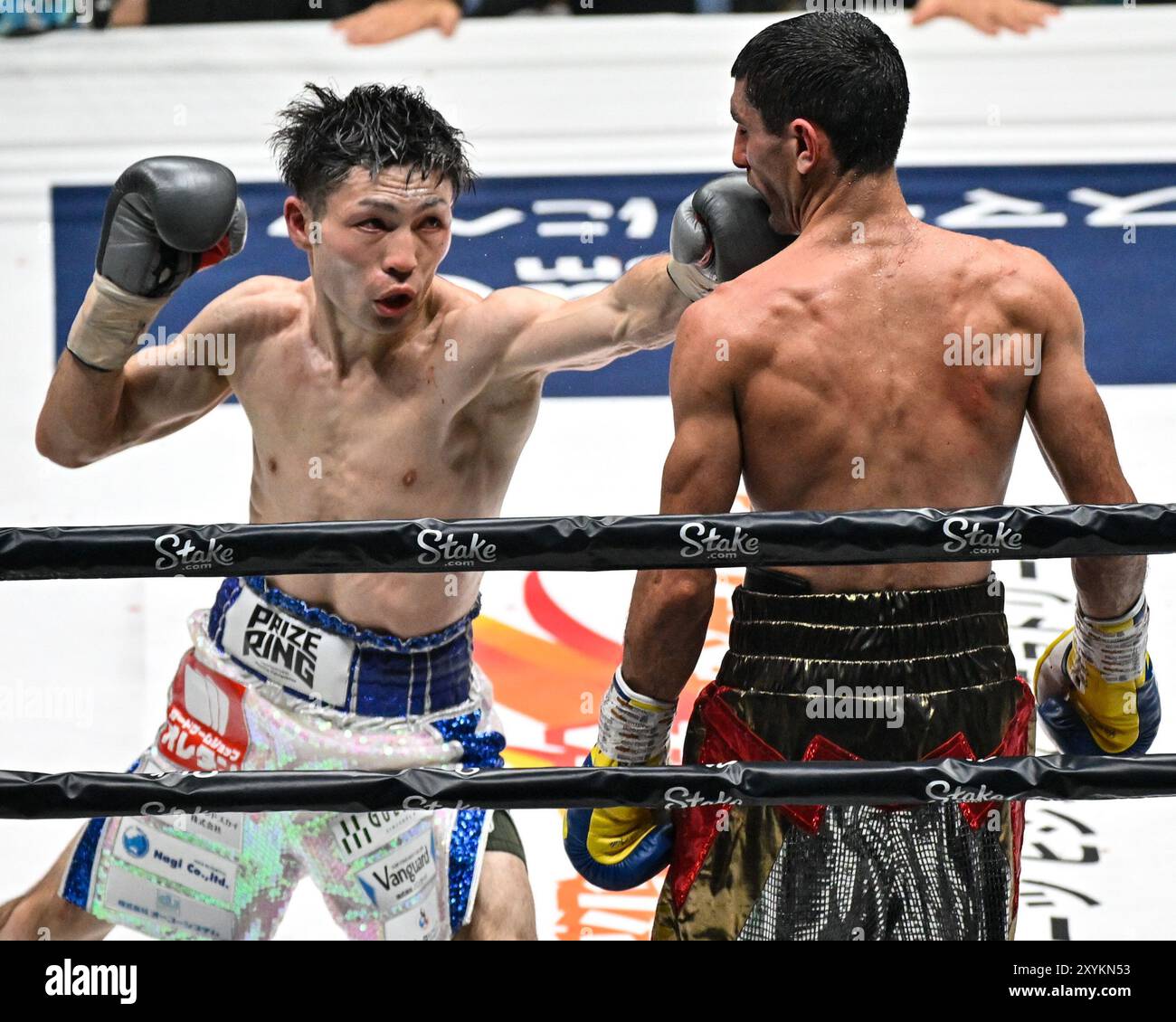 Japan's Seigo Yuri Akui (gray gloves) hits Ukraine's Artem Dalakian ...