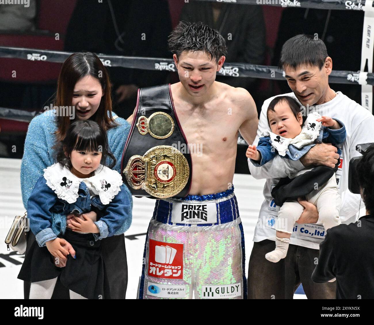 Japan's Seigo Yuri Akui, center, celebrates with his wife Yume, left ...