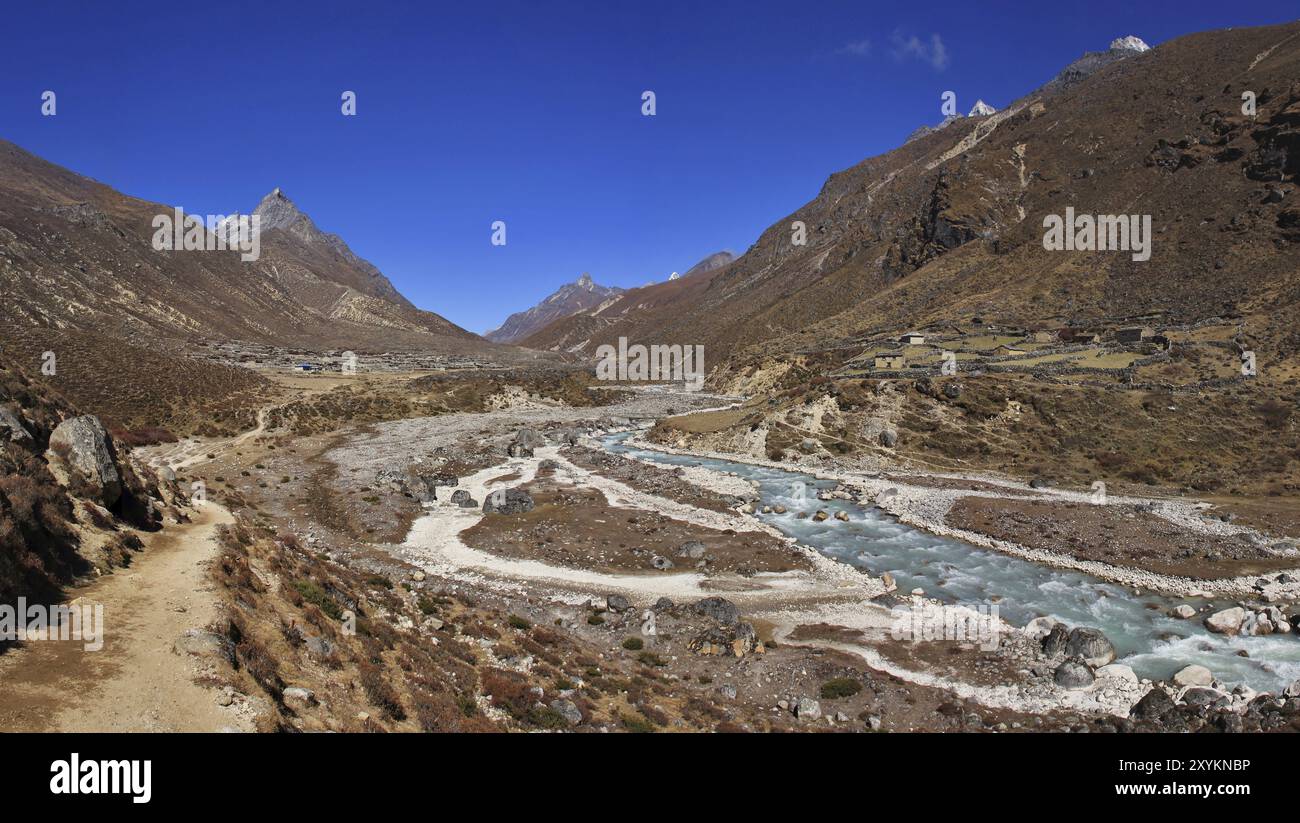 Scene in the Thame valley. Trekking trail following the Bhote Kosi ...