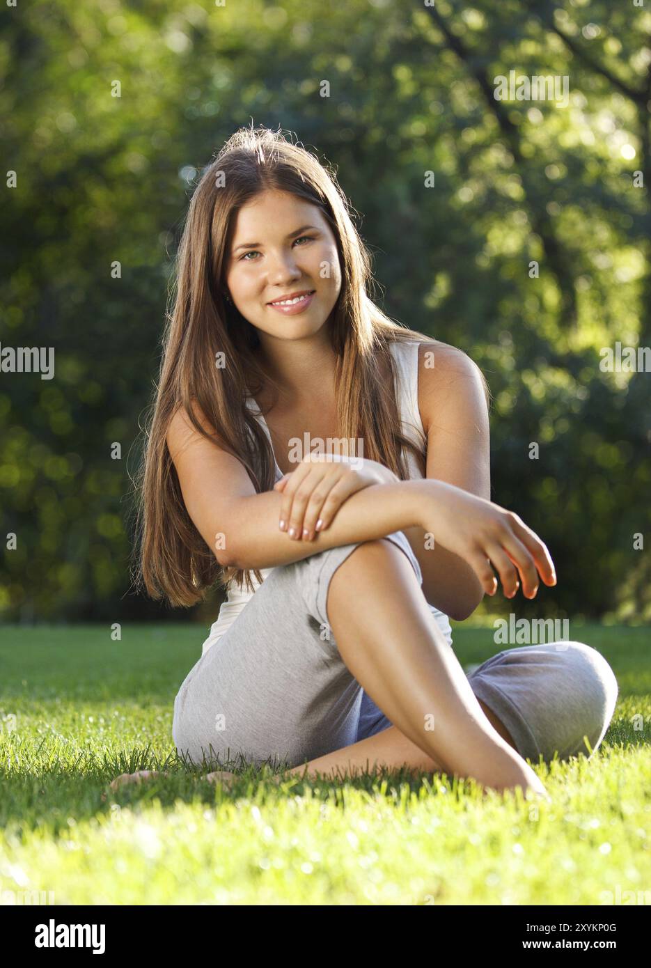 Beautiful young girl with open smile in summer park Stock Photo - Alamy