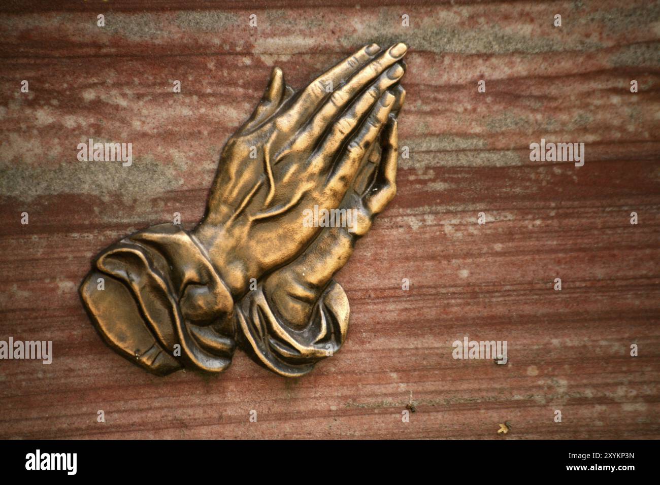 Praying hands a tombstone hi-res stock photography and images - Alamy