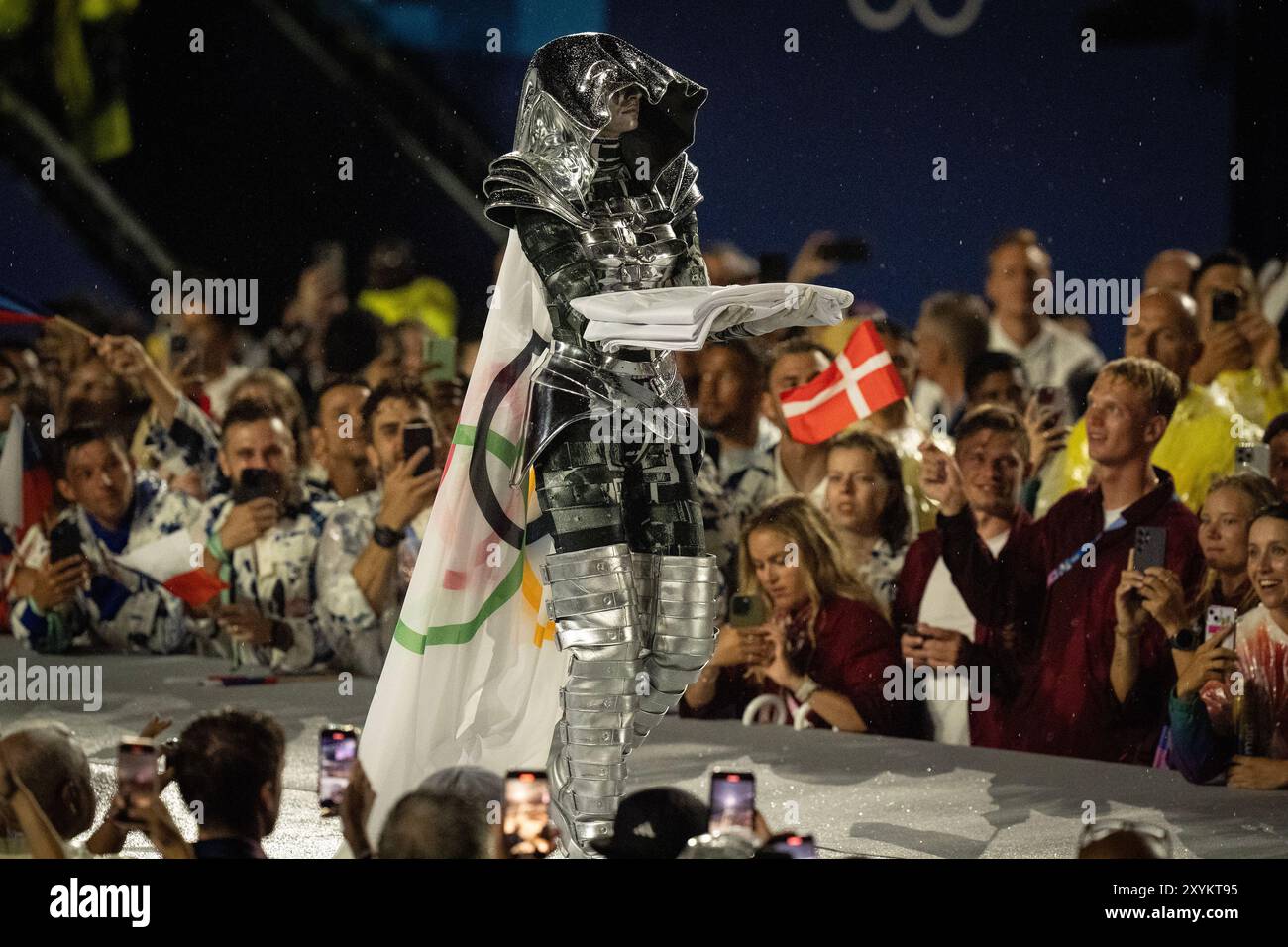 The Olympic flag is carried during the opening ceremony of the 2024 ...