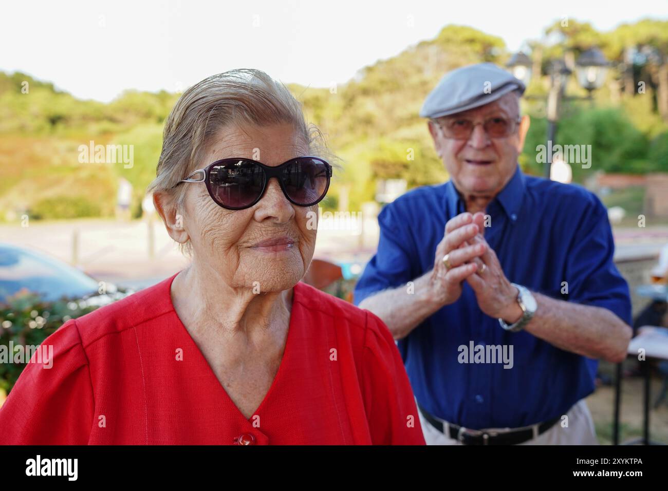 elderly couple having fun and socializing with friends outdoors ...