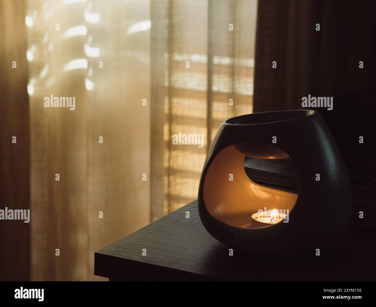 Warm Glow of a Tea Candle in a Cozy Italian Home. Horizontal Close Up ...