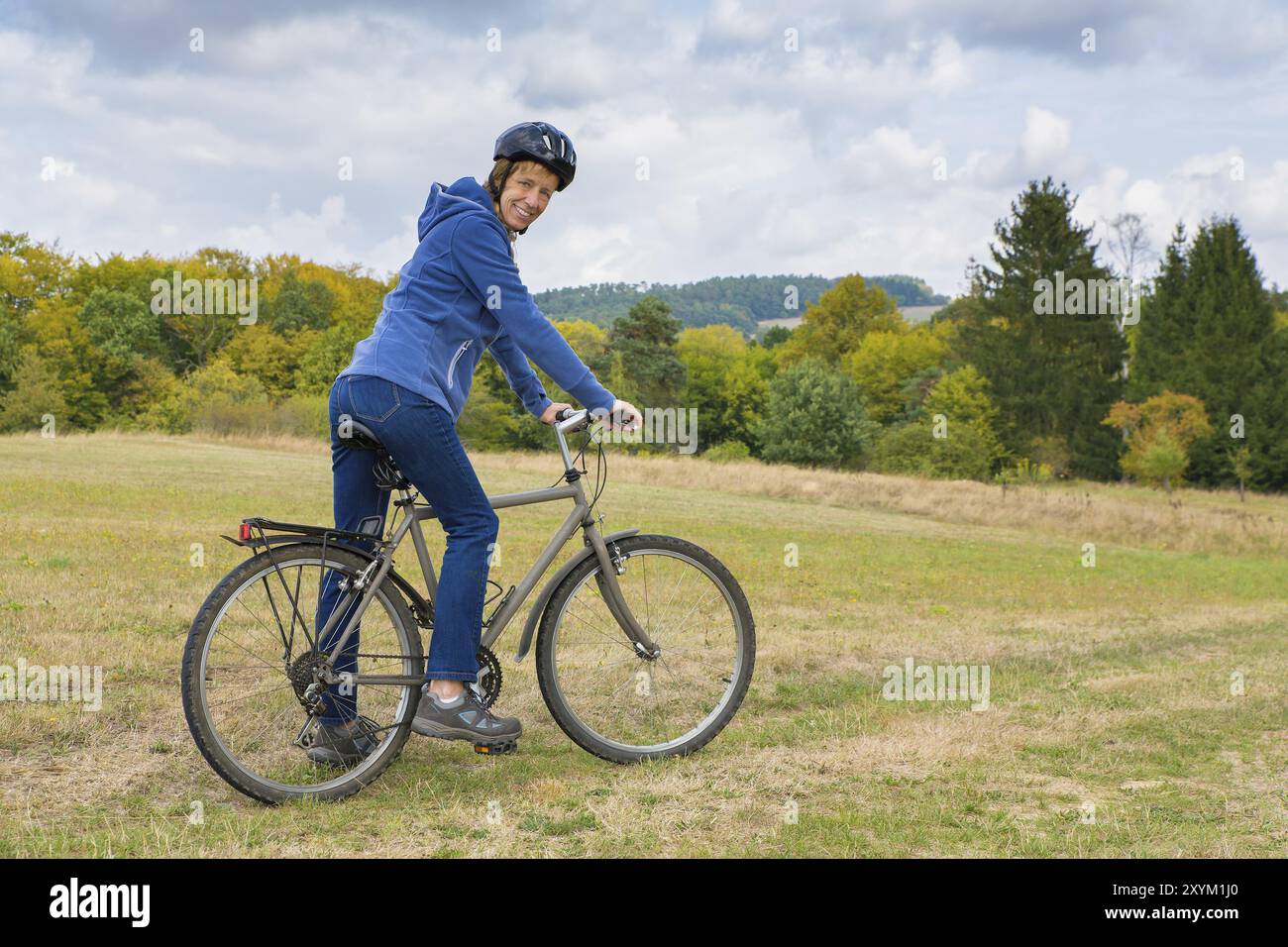Shot woman riding bike on hi-res stock photography and images - Alamy