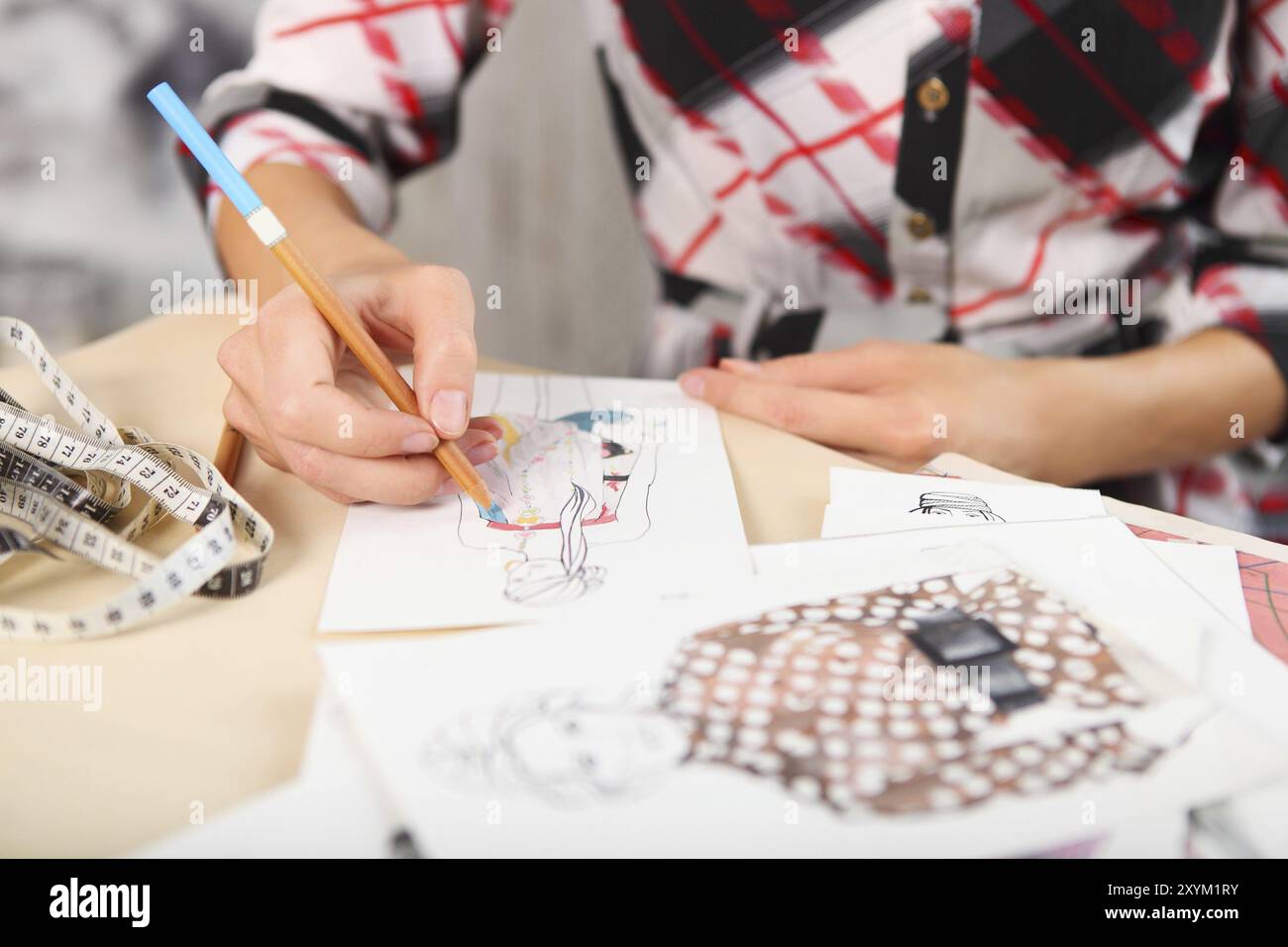 Dressmaker is drawing a fashion sketch. Close up of the hands Stock ...