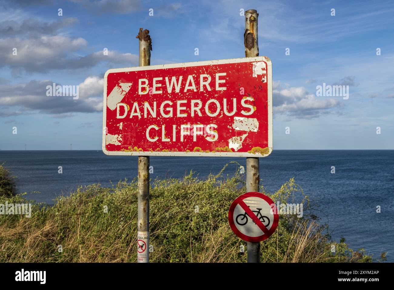 Sign: Beware dangerous cliffs, seen in Hartley, Northumberland, England ...