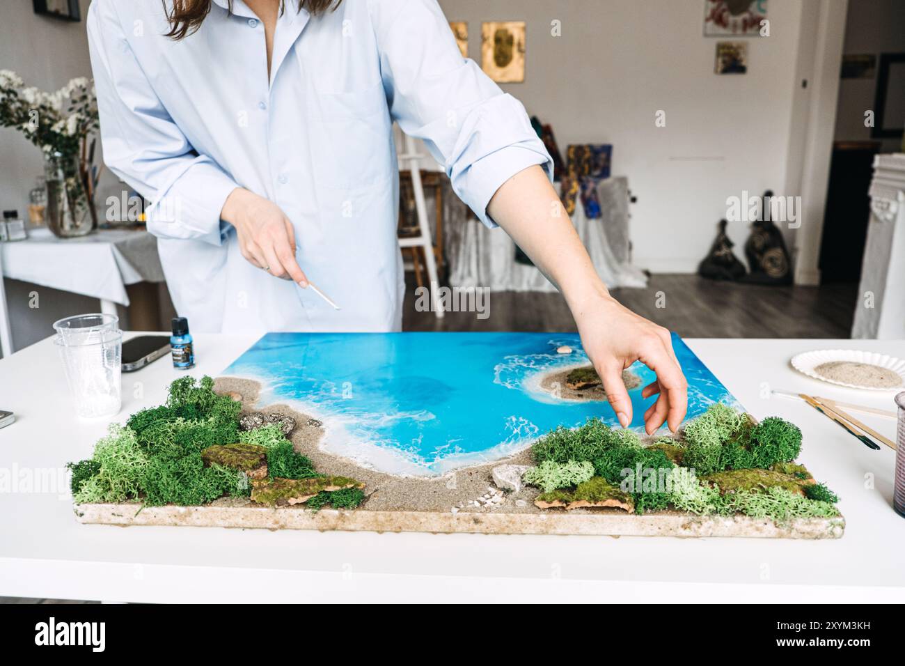 Hands crafting resin art coastal landscape, DIY project, handmade beach ...