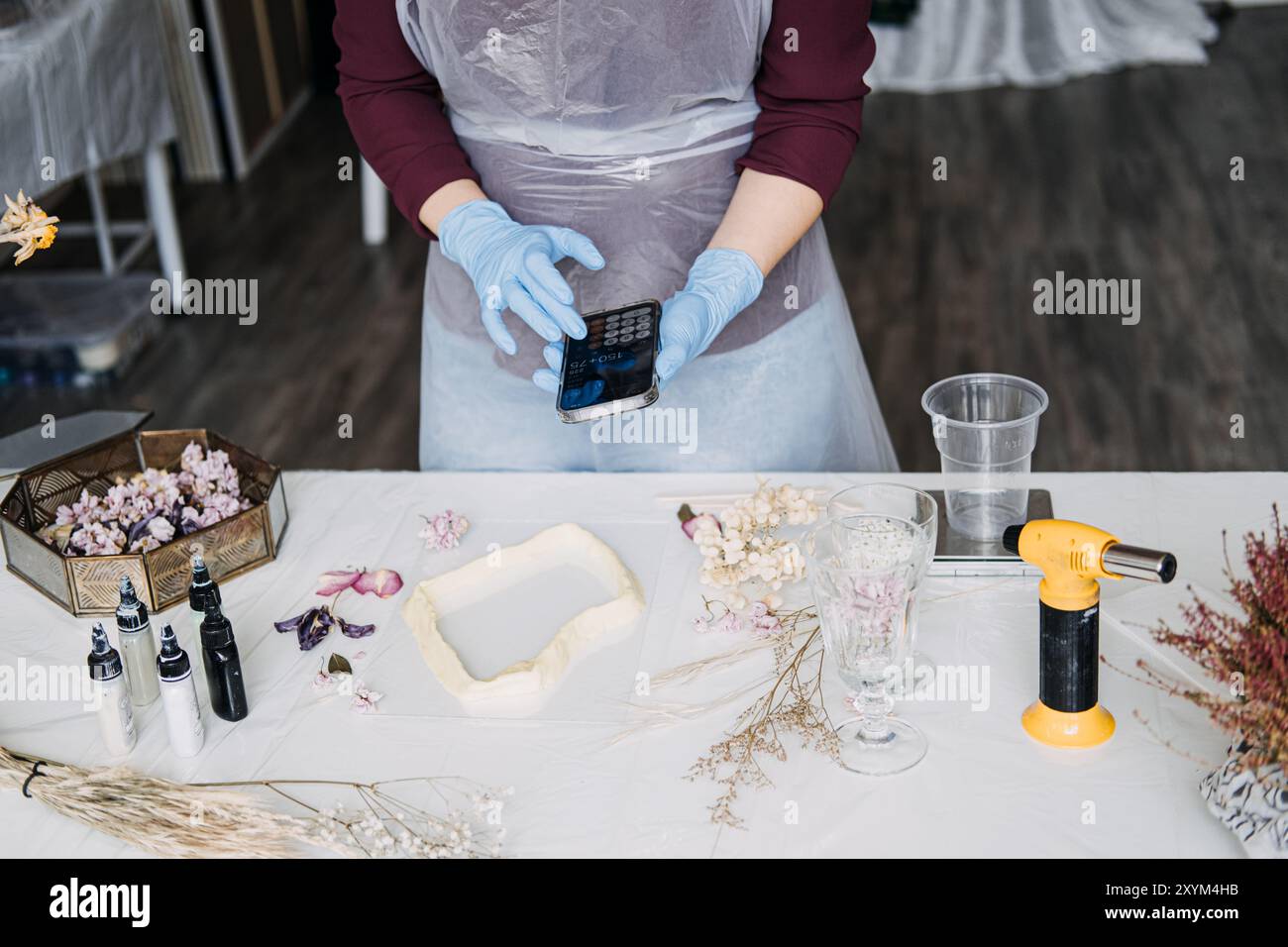 Crafting process with precise measurements, artisan calculating resin ...