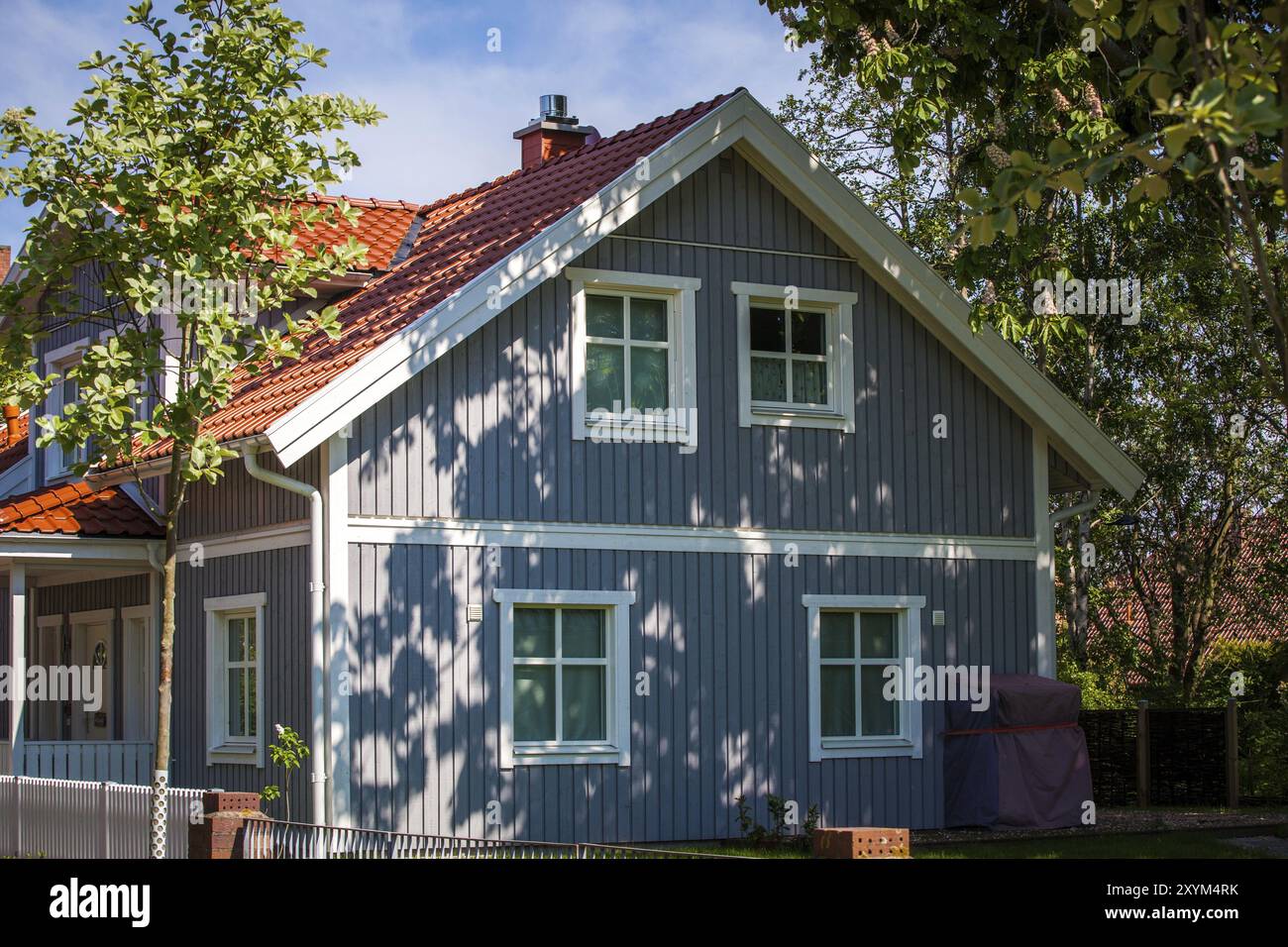 Blue wooden house with different sized windows Stock Photo - Alamy