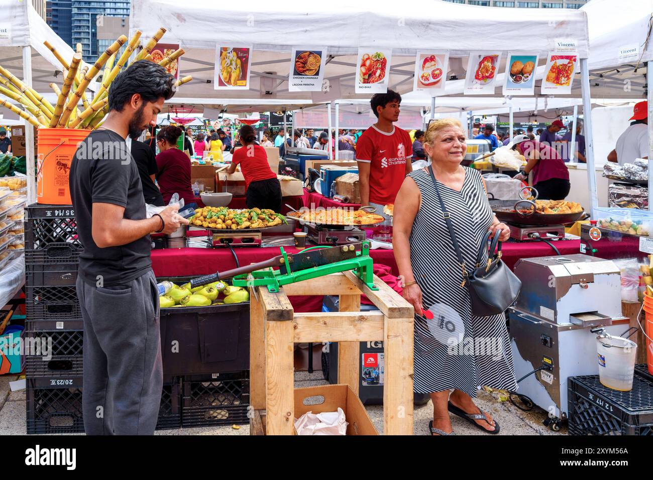 People at a market stall selling food during the Taste of India ...