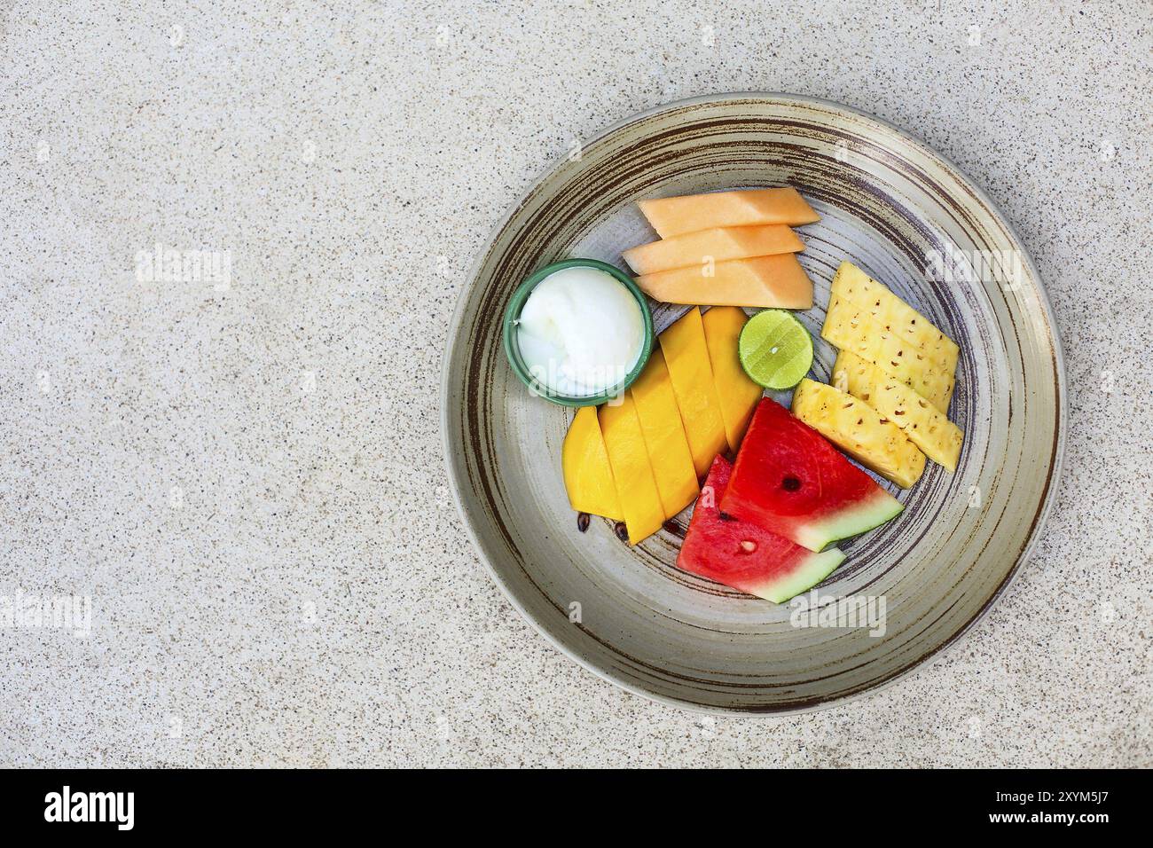 Colorful summer fruit platter with watermelon, mango, pineapple, lime ...