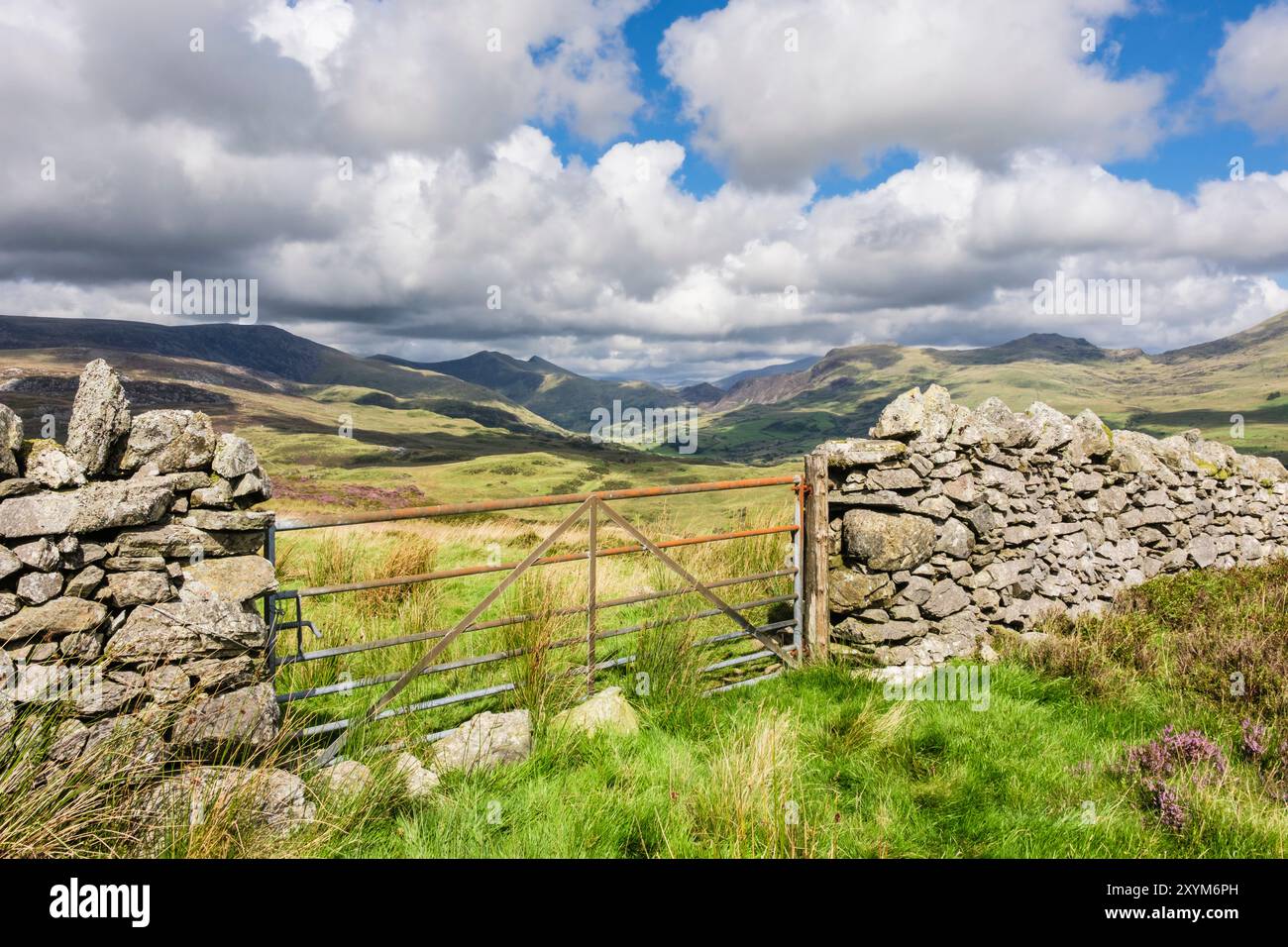 Scenic view through farm gate to mountains above Cwm Pennant in ...