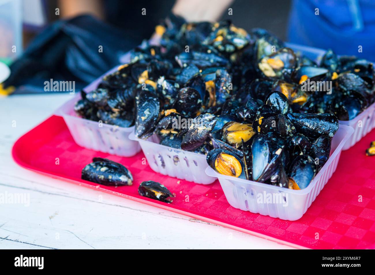 Close-up of 6 mussels servings on a red tray at 2024 "Poissonade ...