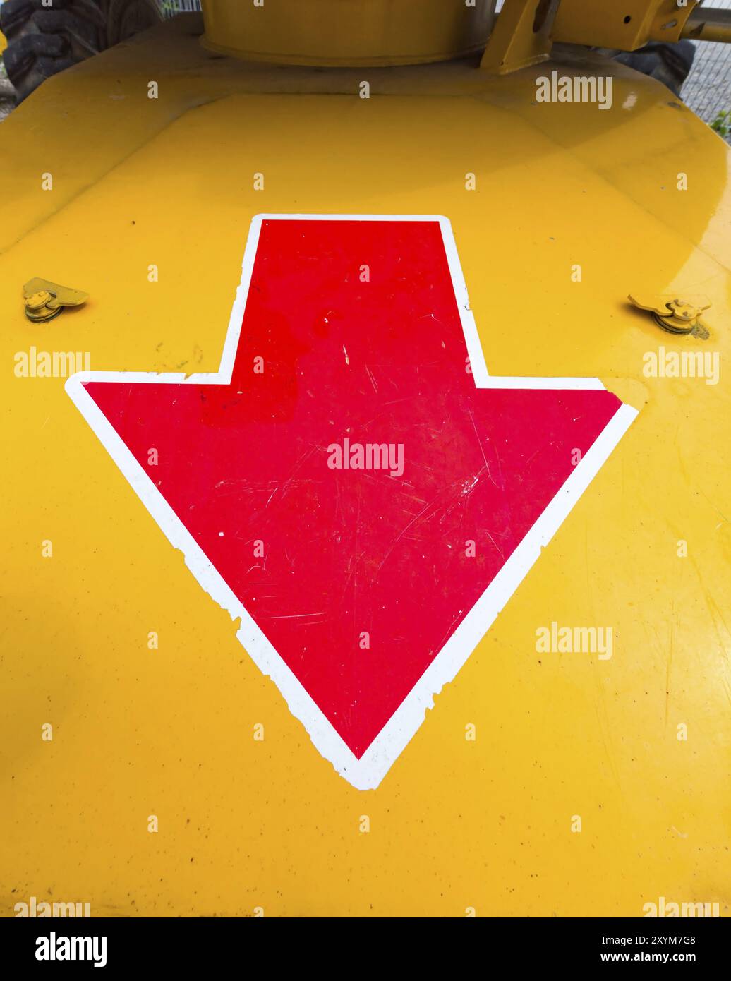 Red arrow pointing downwards on a machine Stock Photo - Alamy