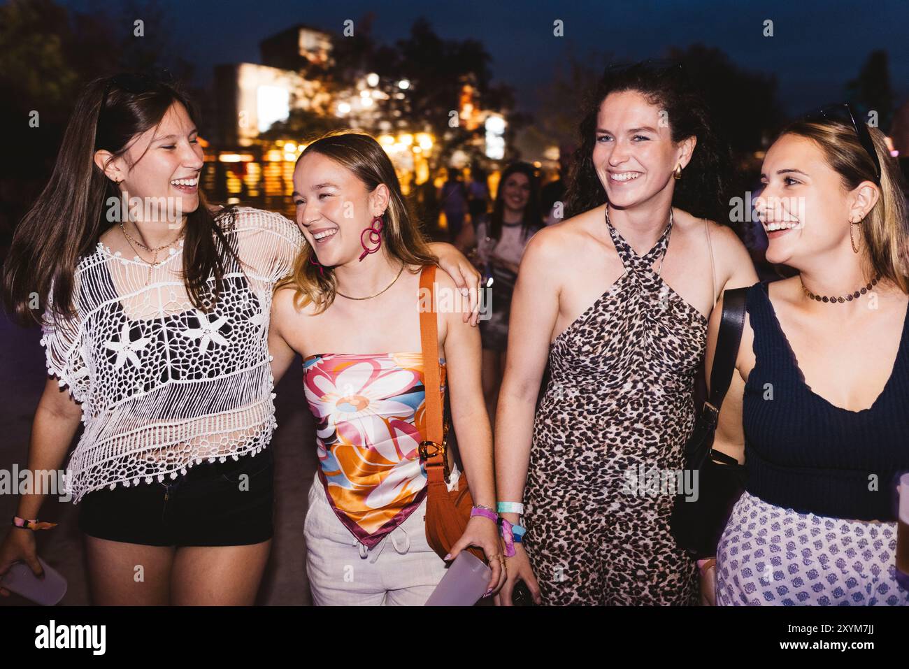 Group of four young smiling women enjoying their time at an outdoor ...
