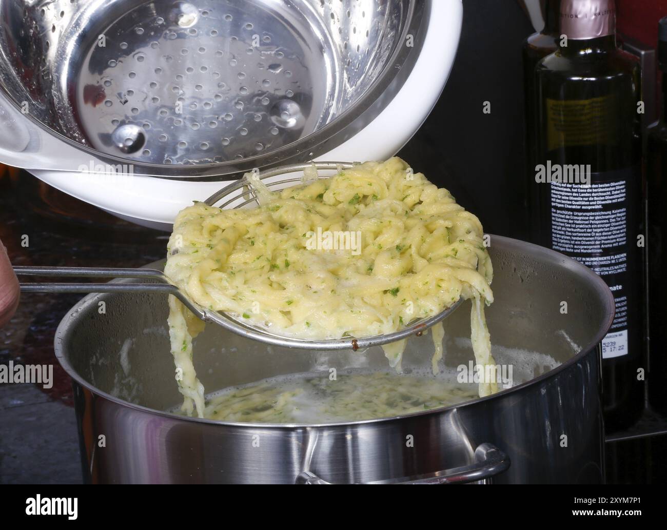 Swabian cuisine, preparation of herb spaetzle for roast beef, scooping ...